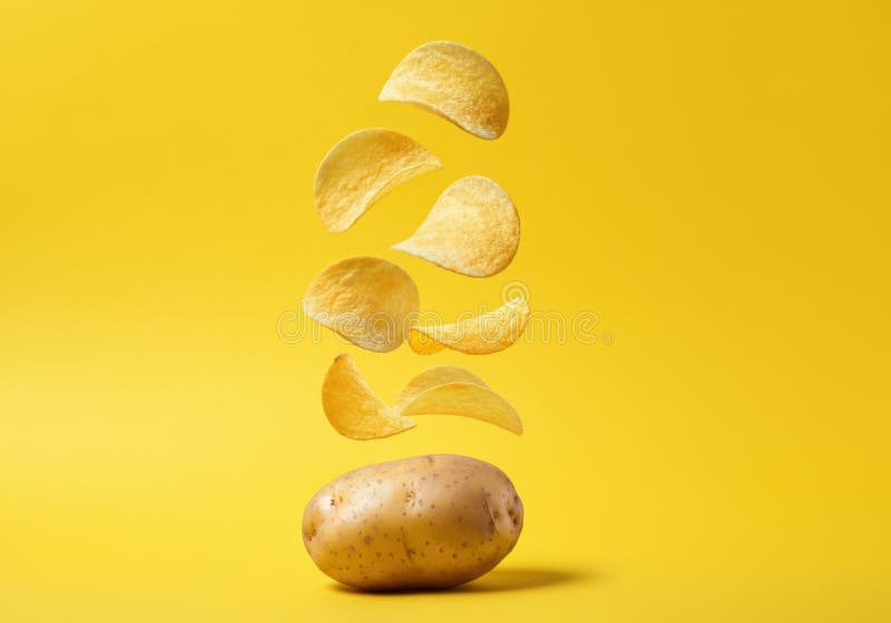Potato with Floating Potato Chips Against a Vibrant Yellow Background ...