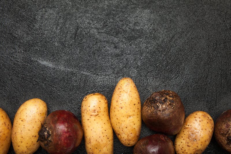 Potato and Red Beets Tubers on a Black Table. Copy Space Stock Image ...
