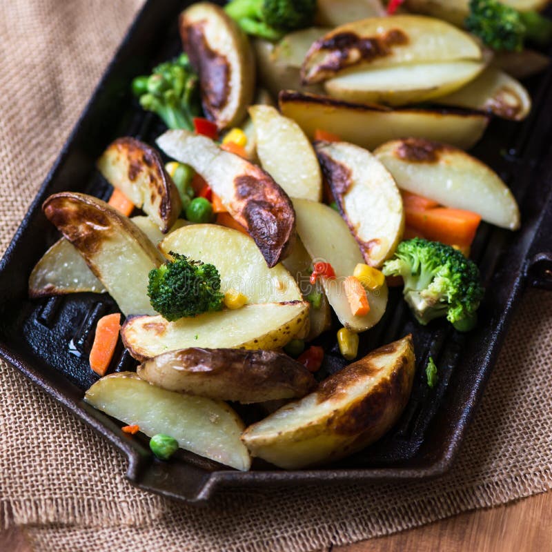 Potato Wedges with Vegetables on Iron Cast Pan Stock Photo - Image of ...