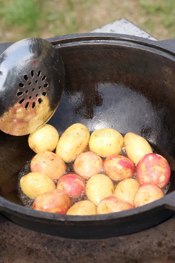 Potatoes in a Cast Iron Pot. Fried in Oil Over an Open Fire. Close-up ...
