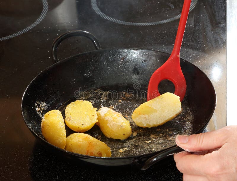 Potatoes cooking in a pan stock photo. Image of black - 38759694