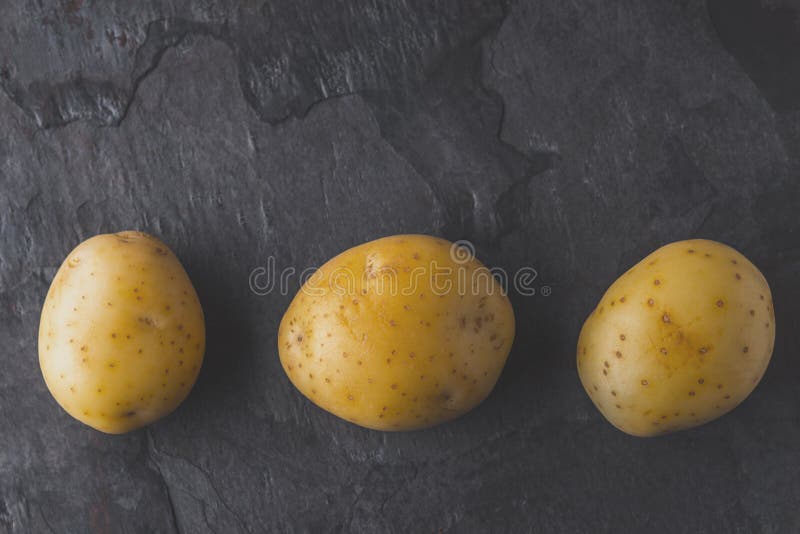 Potatoes on the Dark Stone Table Top View Stock Photo - Image of ...