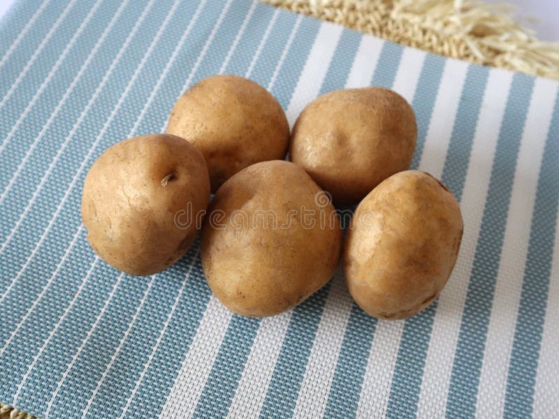 Fresh Medium Size Potatoes on a Plate Stock Photo - Image of backdrop ...