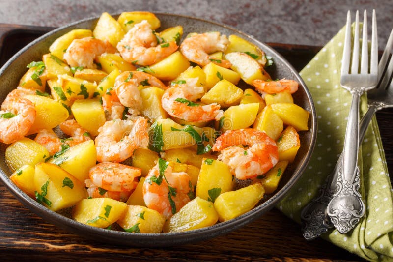 Potatoes Sauteed with Shrimp and Garlic Close-up in a Plate. Horizontal ...