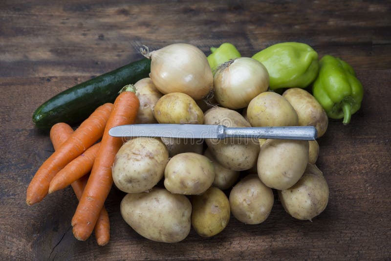 Potatoes and Vegetable on the Rustic Table with Knife Stock Photo ...