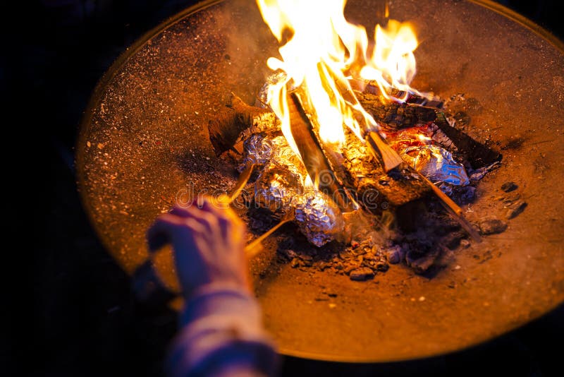 Potatoes Wrapped in Aluminum Foil Baked in a Bonfire. Stock Photo ...