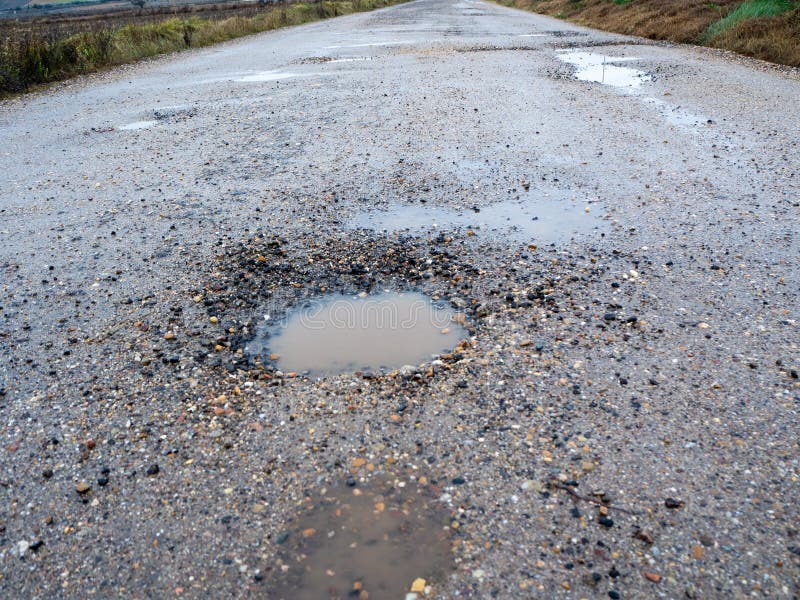 Pothole on a Paved Road on a Rainy Winter Day. Concept of Risk and ...
