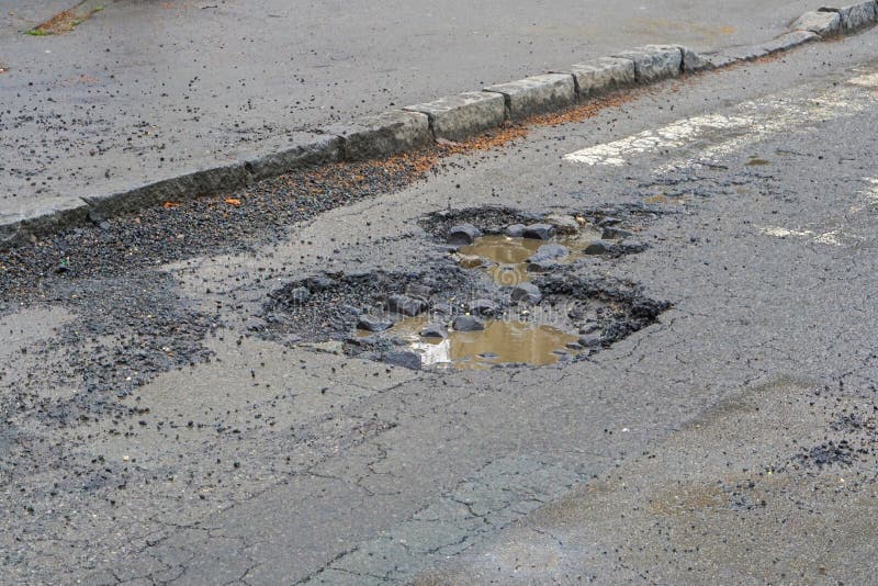 Pothole water street stock photo. Image of filled, road - 231231924