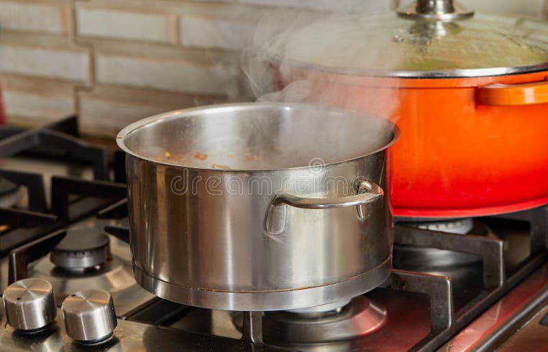Pots with Steam Boiling on Gas Stove in the Kitchen Stock Image - Image ...