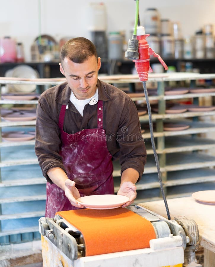 Potter Refining Edges of Ceramic Plates Using Sanding Belt Machine ...