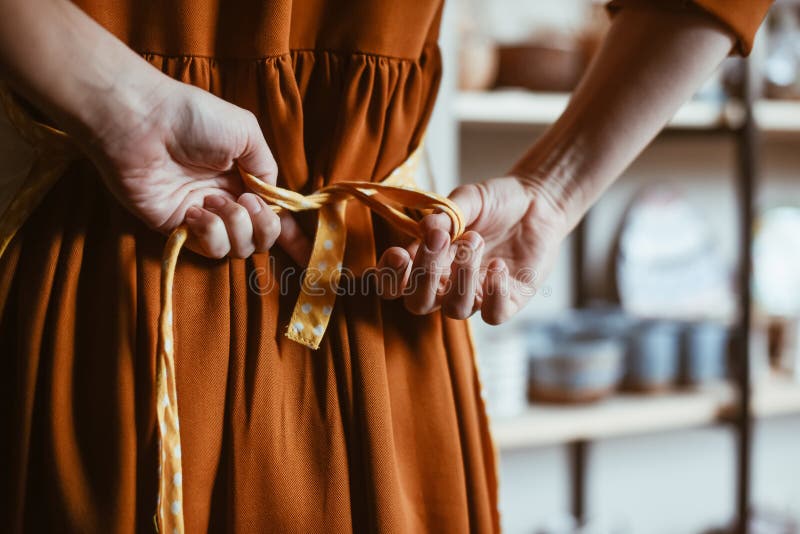 Potter Woman Getting Ready for Work by Putting on Apron Stock Photo ...