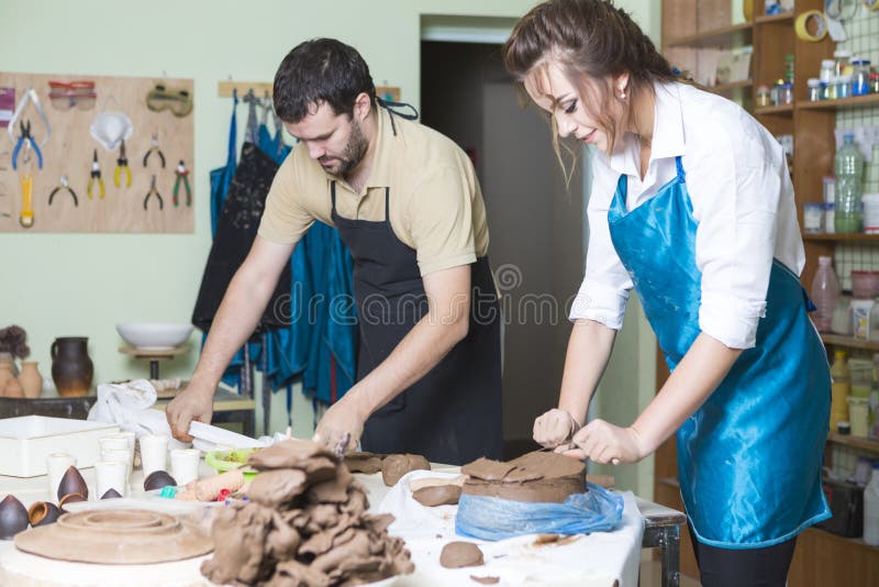 Pottering and Claymaking Process Concept. Two Professional Ceramists or ...