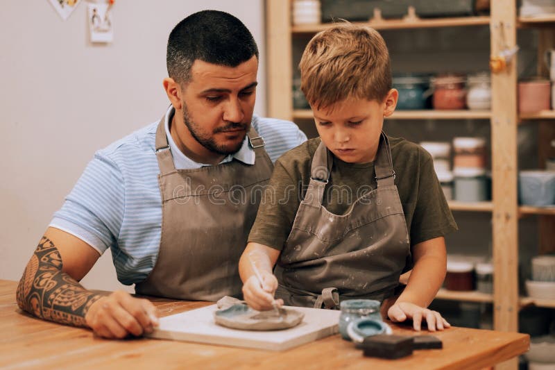 Pottering with Son. Confident Young Man and Little Boy Making Ceramic ...