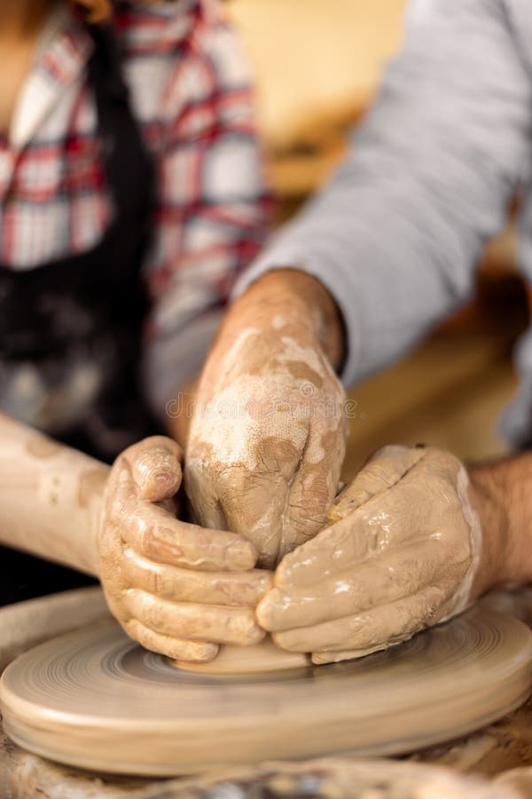 Potters Hands Guiding a Woman Hands To Help Her To Work with the ...