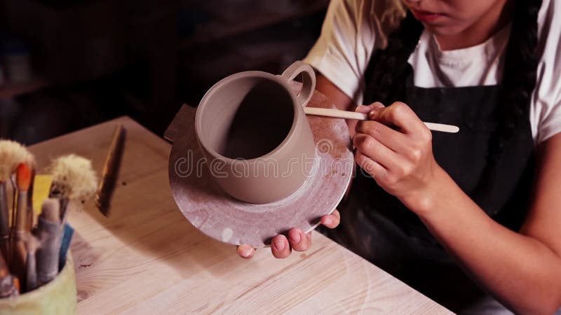 Pottery in the Art Studio - Asian Woman Holding a Cup on the Plate and ...
