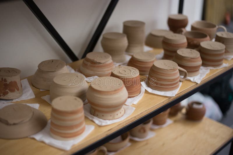 Pottery Cups, Plates Made of Clay Dry on a Shelf Stock Photo - Image of ...