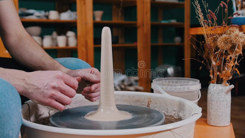 Pottery - Potter Master is Pulling Clay in Length on a Potter`s Wheel ...