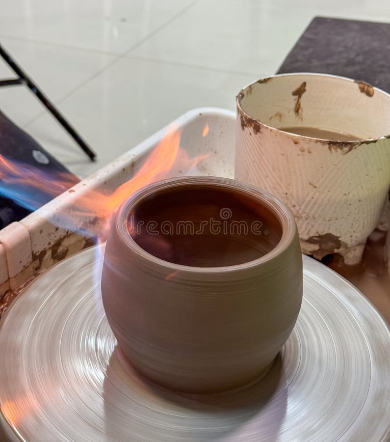 A Pottery Wheel with a Clay Vase in the Firing Process. Flames Create a ...