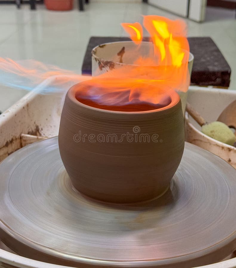 A Pottery Wheel with a Clay Vase in the Firing Process. Flames Create a ...