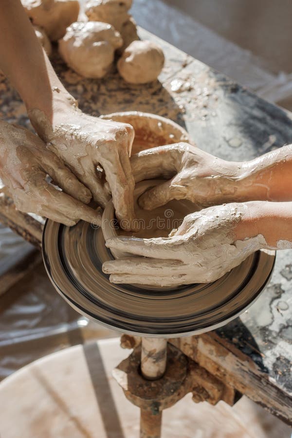 Pottery Wheel Modeling Lesson. Hands of Master and Apprentice Stock ...