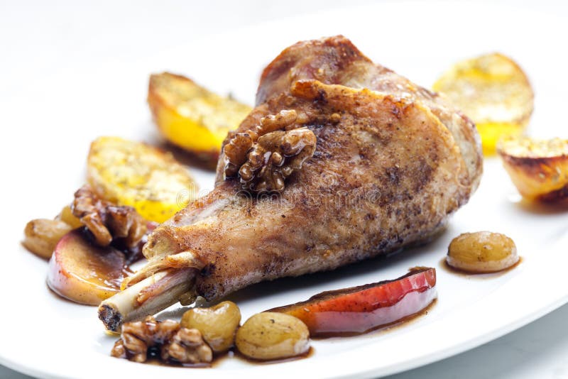 Poultry Leg Baked with Fruit and Walnuts Served with Fried Potatoes ...