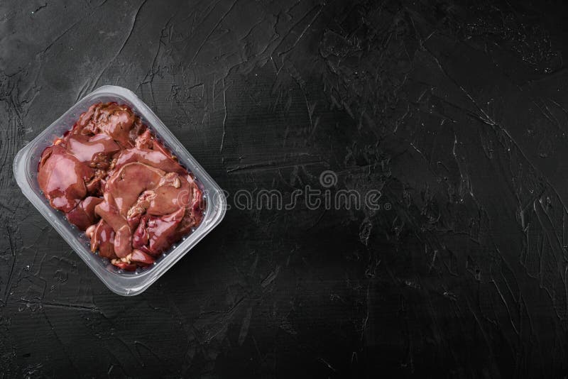 Poultry Offal Chicken Liver in a Plastic Container, on Black Dark Stone ...