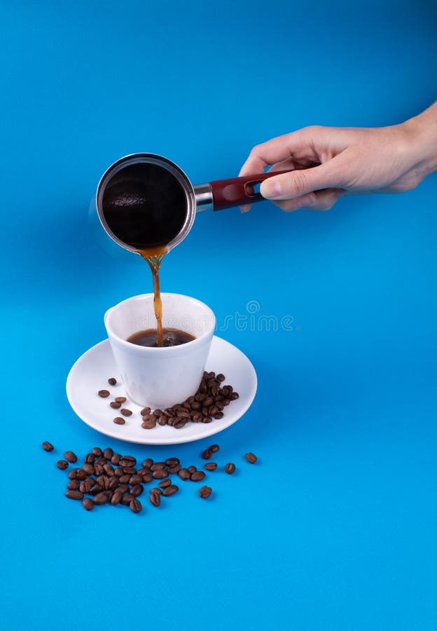 Pour Coffee in a Cup on the Background of Coffee Grains Stock Image ...