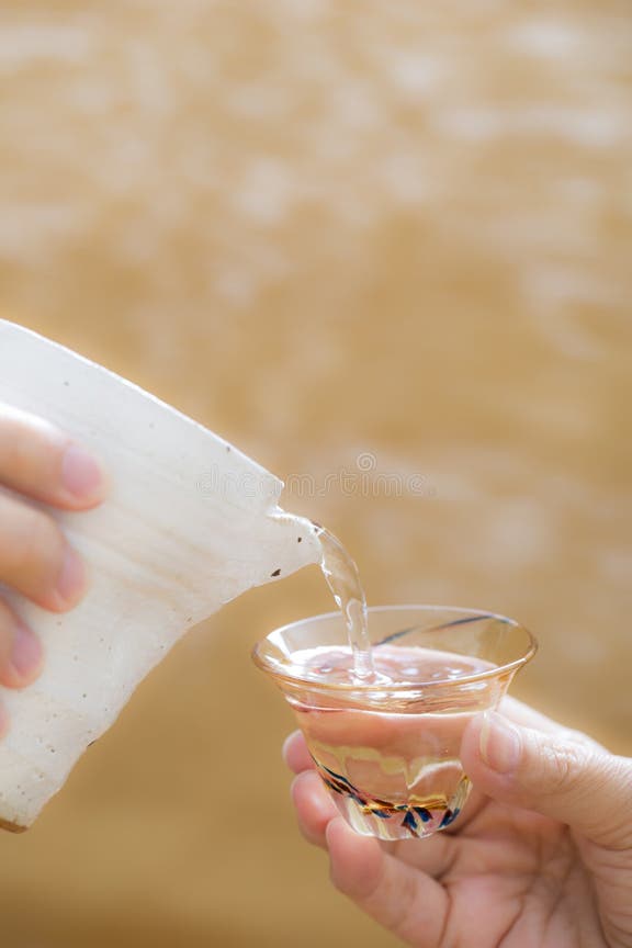 Pouring cold sake stock image. Image of japanese, transparent - 170097981