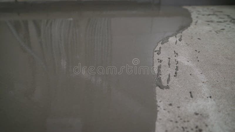 Pour the Liquid Floor Onto the Concrete Surface. Leveling the Floor ...