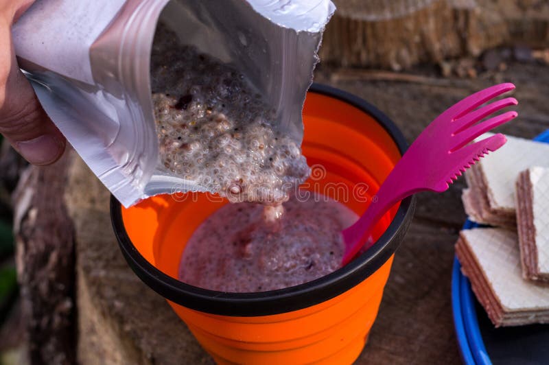 Pour Out Food from the Package. Pour Food into the Dishes Stock Photo ...
