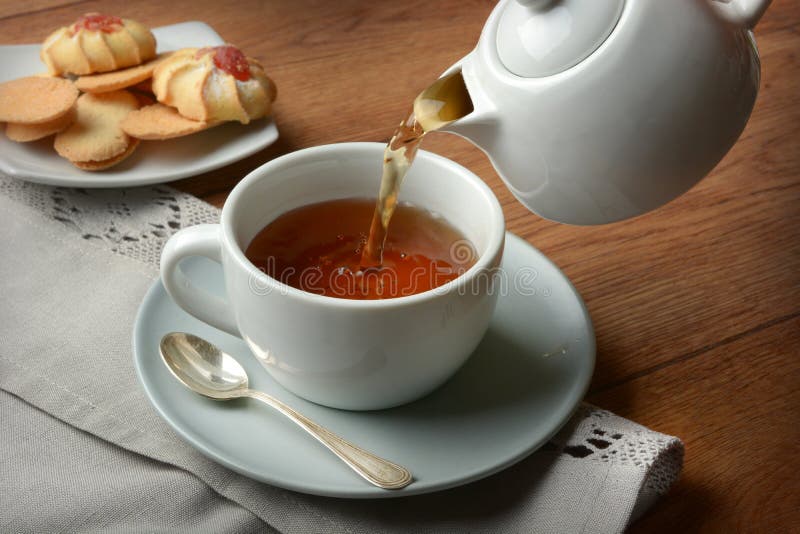 Pour the tea into the cup stock photo. Image of wooden - 116284798