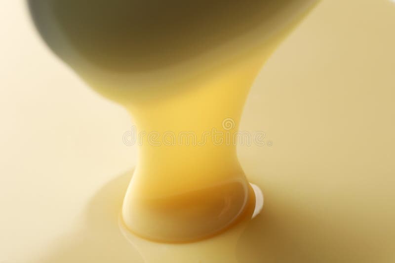 Poured Condensed Milk on Whole Background, Close Up Stock Photo - Image ...