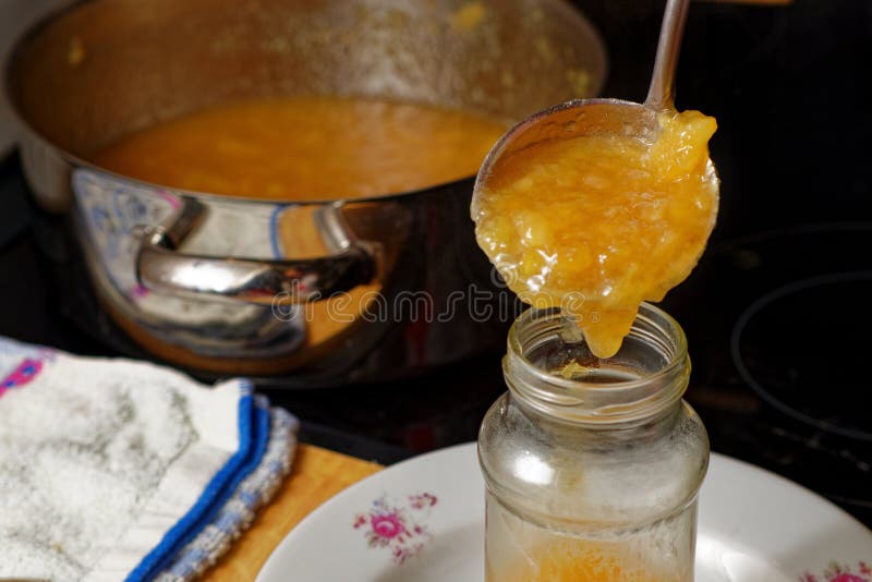 Pouring apple jam in jar stock image. Image of homemade - 337370047