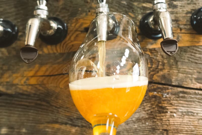 Pouring Beer Into A Glass From The Tap At Bar Beer Bottling Stock