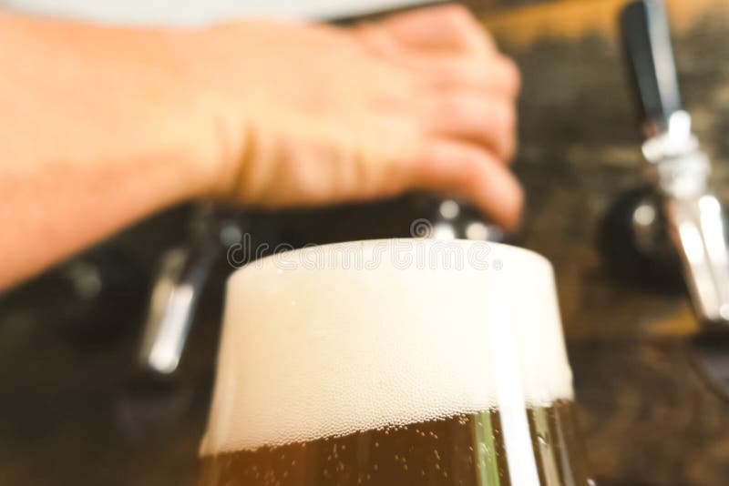 Pouring Beer Into A Glass From The Tap At Bar Beer Bottling Stock