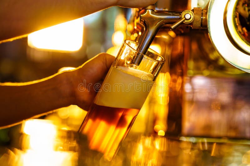 Pouring beer stock photo. Image of alcohol, light, person - 74914412