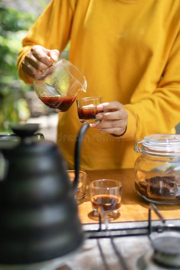 Pouring Black Coffee from a Glass Carafe into a Glass Stock Photo ...
