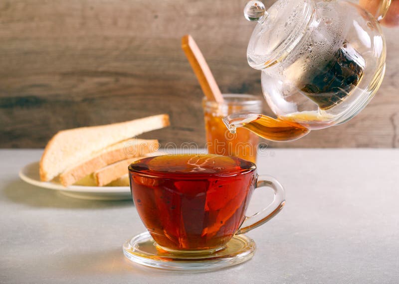 Pouring Black Tea in To Transparent Glass Stock Photo - Image of ...