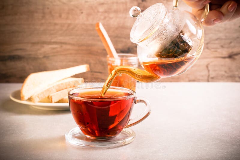 Pouring Black Tea in To Transparent Glass Stock Photo - Image of ...