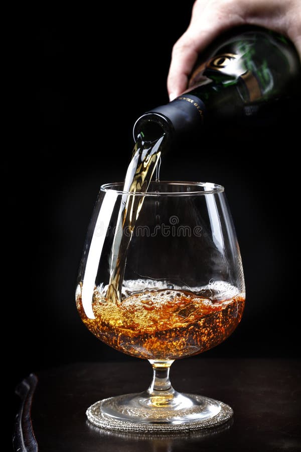 Pouring brandy stock image. Image of flowing, beverage - 18506607