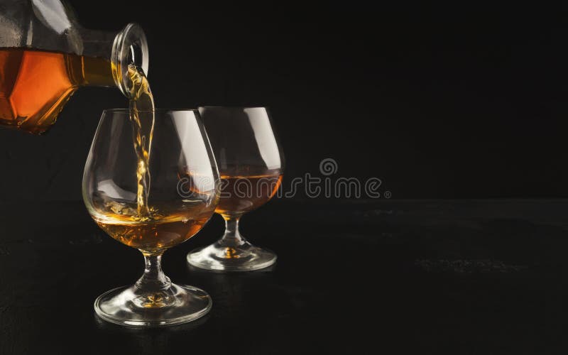 Pouring Brandy or Cognac from Bottle into Glass Stock Image - Image of ...