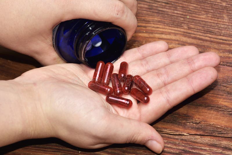 Pouring Capsules from a Pill Bottle Stock Image - Image of adult ...