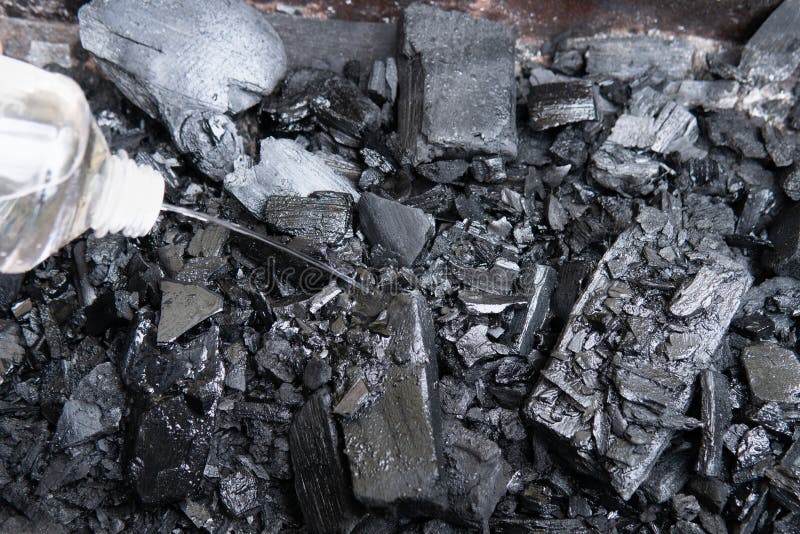 Pouring Charcoal Ignition Fluid before Lighting the Barbecue Charcoal ...