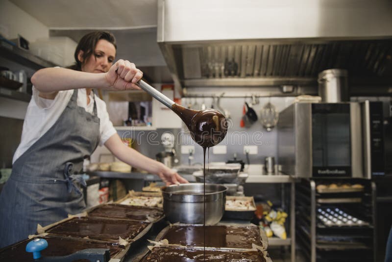 Pouring the Chocolate stock photo. Image of occupation - 131051948
