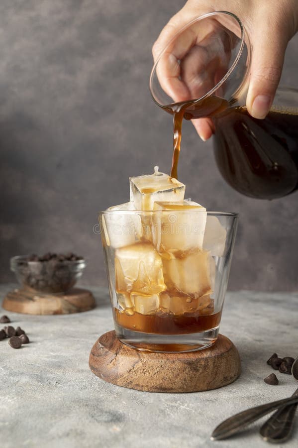 Pouring Coffe Over Cup with Ice Cubes in Glass. Preparing Refreshing ...