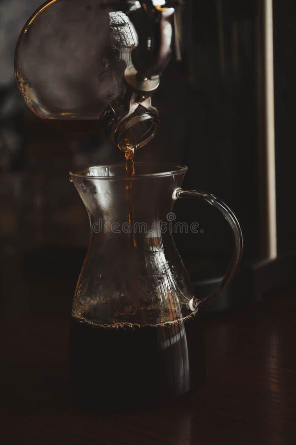 Pouring Coffee into Glass Jug on Wooden Table in Cafe Stock Photo ...