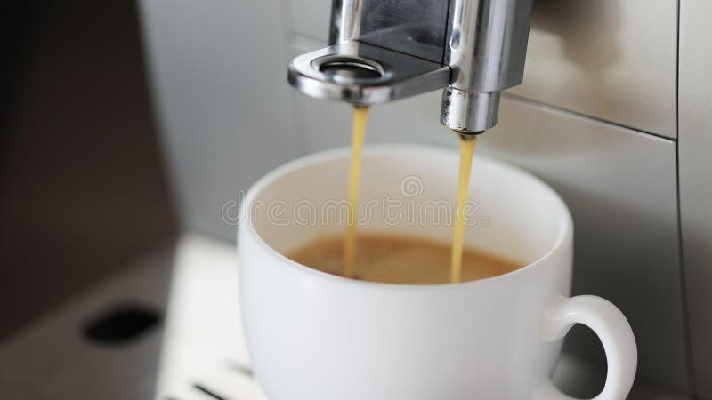 Pouring Coffee Stream from Machine in Cup. Home Making Hot Espresso ...
