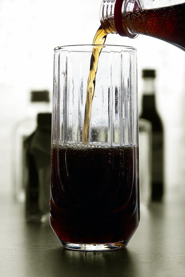 Pouring coke in the glass stock image. Image of pouring - 146790631