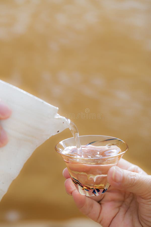 Pouring Sake into a Small Japanese Cup Stock Image - Image of brewed ...