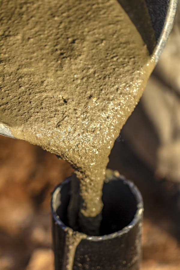 Pouring the Concrete Mixture into the Pile Foundation. Cement Work. the ...